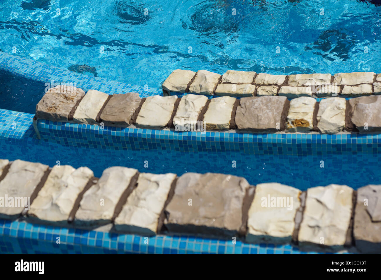 swimming pool blue water detail in summer time Stock Photo - Alamy