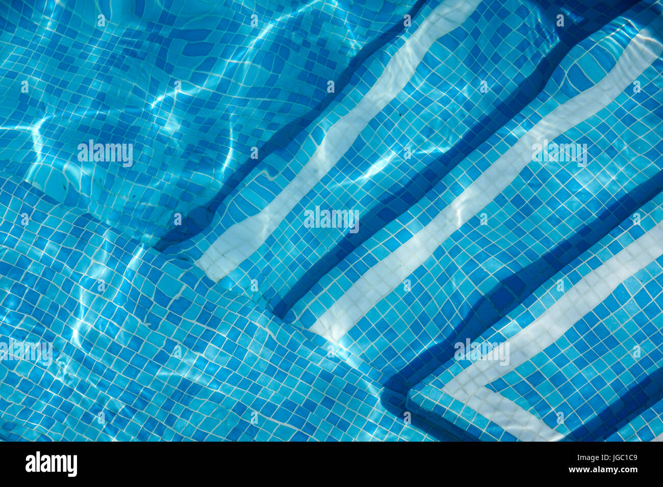 swimming pool blue water detail in summer time Stock Photo - Alamy