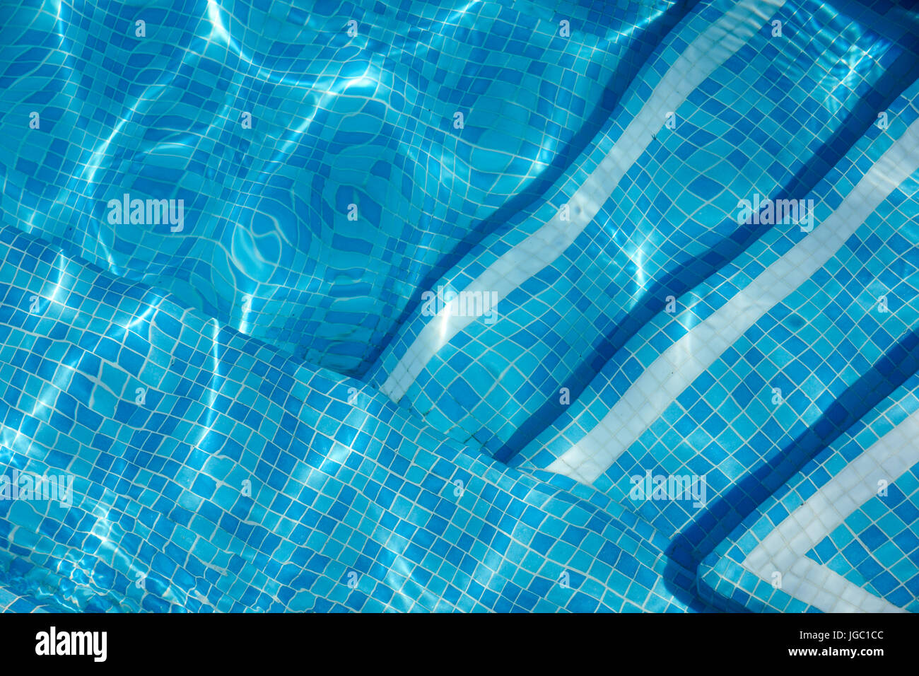 swimming pool blue water detail in summer time Stock Photo - Alamy