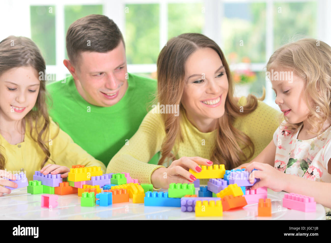 Family collecting blocks together Stock Photo - Alamy