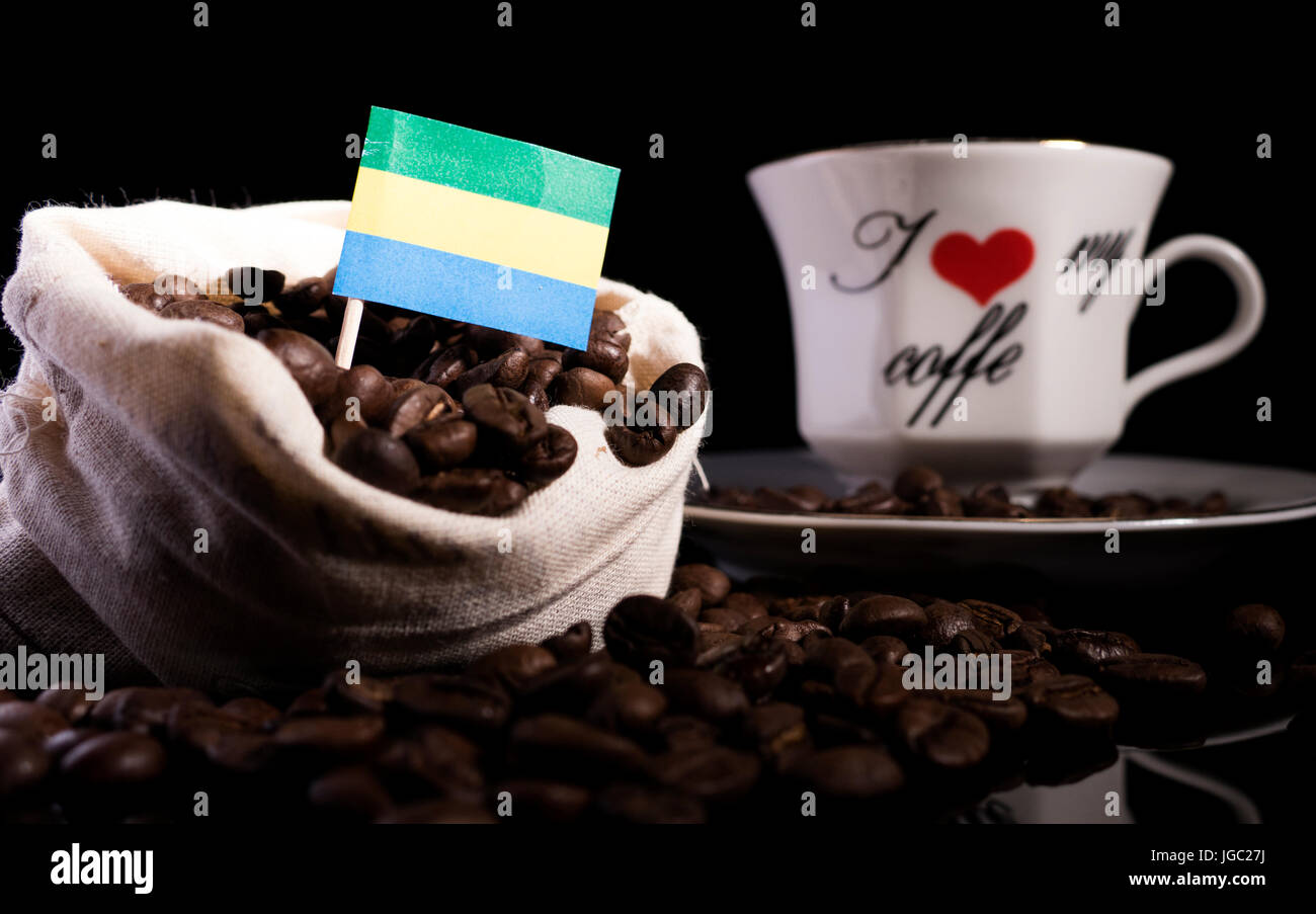 Gabon flag in a bag with coffee beans isolated on black background ...