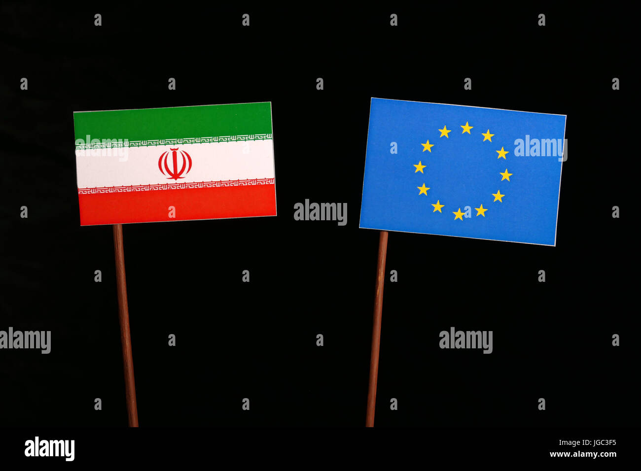 Iranian flag with European Union (EU) flag isolated on black background ...