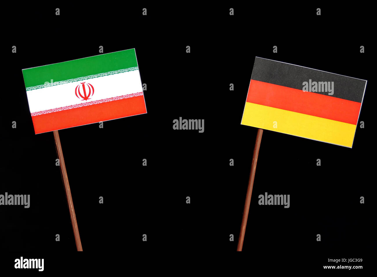 Iranian flag with German flag isolated on black background Stock Photo ...