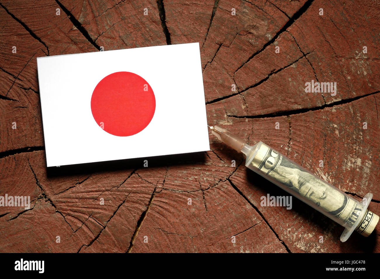 Japanese flag on a stump with syringe injecting money in flag Stock ...