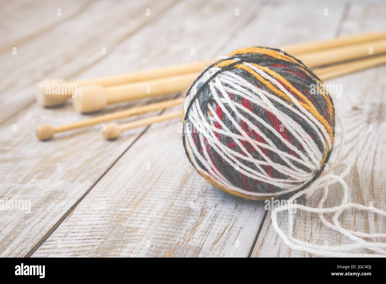 Retro photo of modern color ball of wool with knitting bamboo needles ...