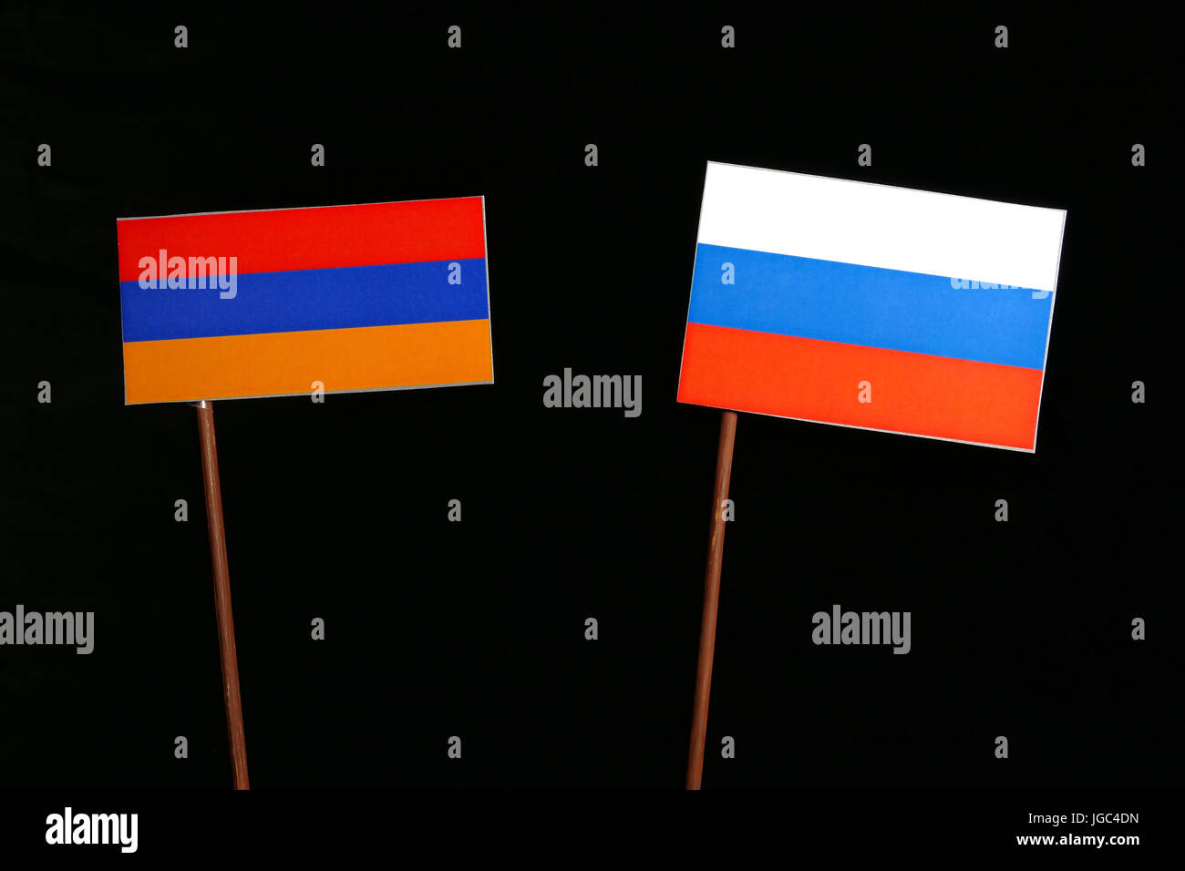 Armenian flag with Russian flag isolated on black background Stock ...