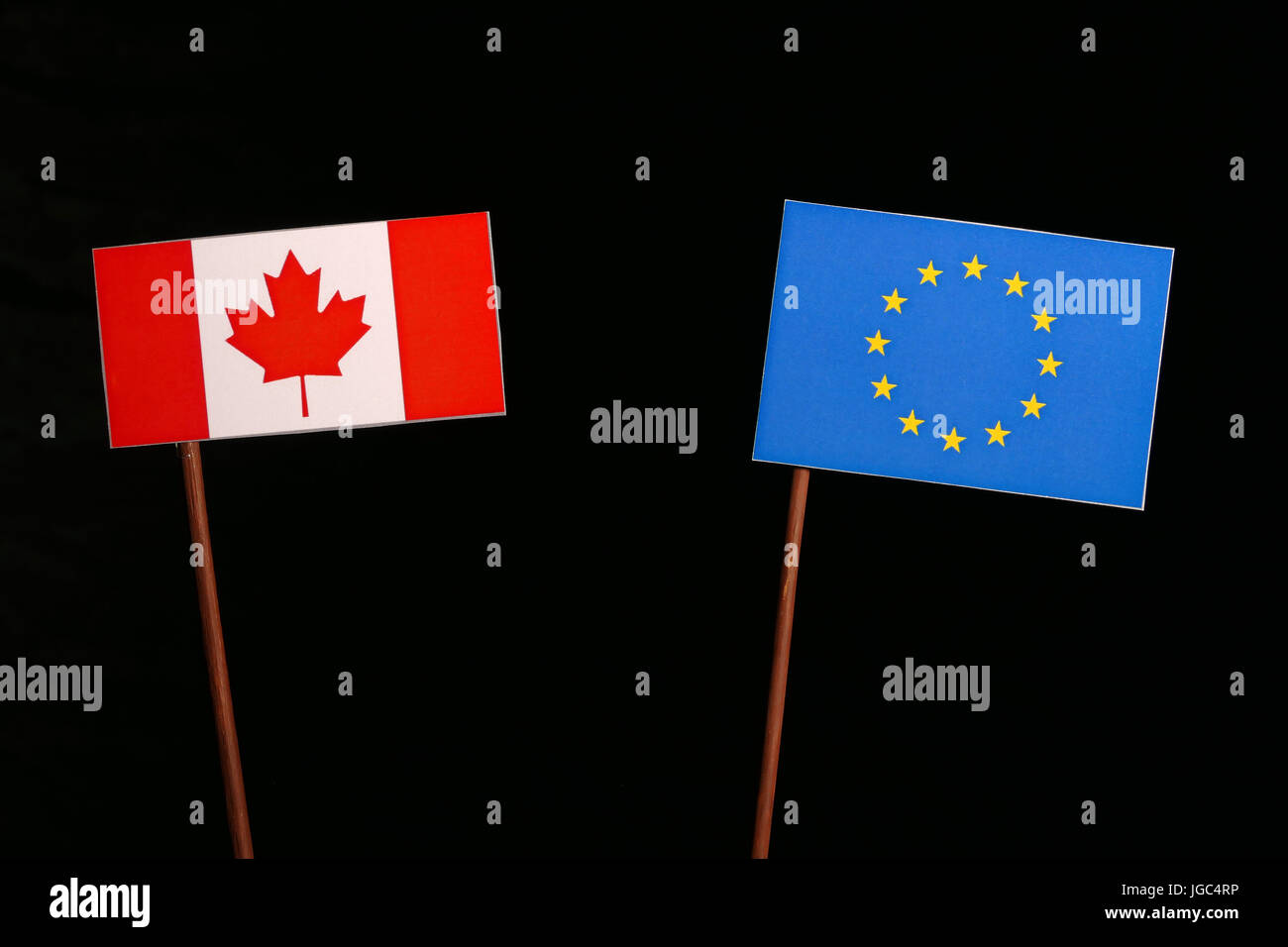 Canadian flag with European Union (EU) flag isolated on black ...
