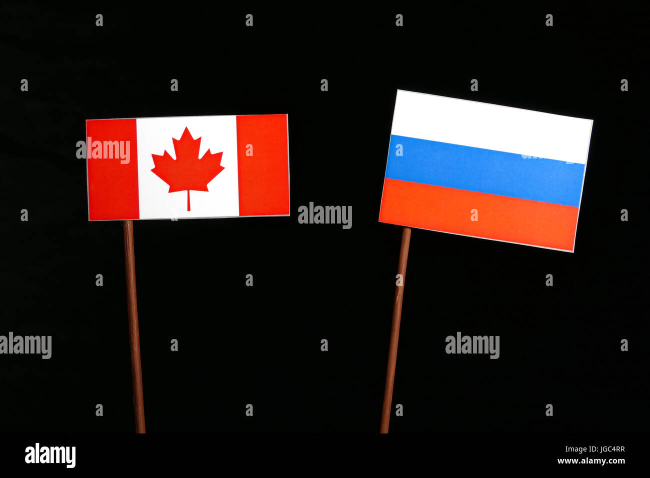 Canadian flag with Russian flag isolated on black background Stock ...