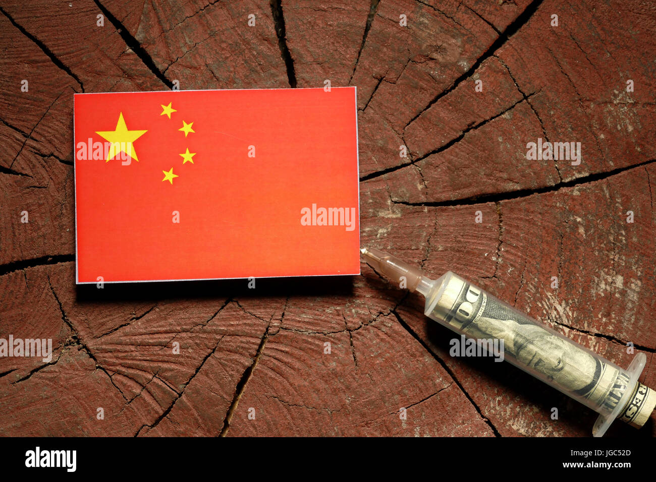 Chinese flag on a stump with syringe injecting money in flag Stock ...