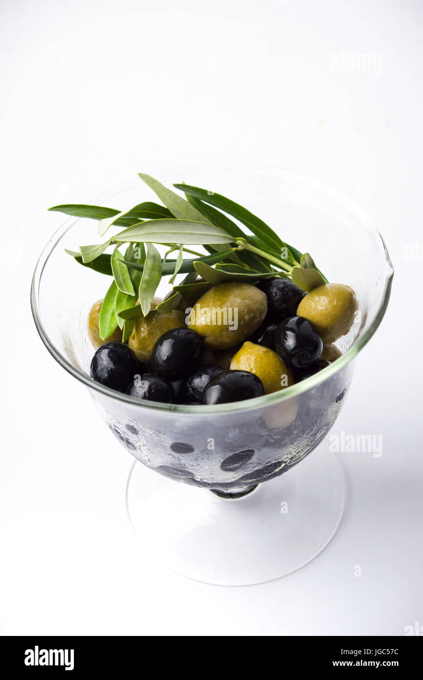 Mixed olives in the glass jar isolated Stock Photo - Alamy