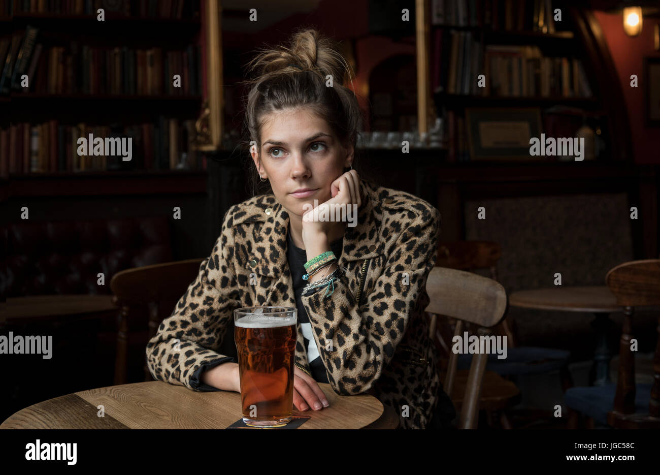 A modern young woman drinking real ale in a London pub Stock Photo - Alamy
