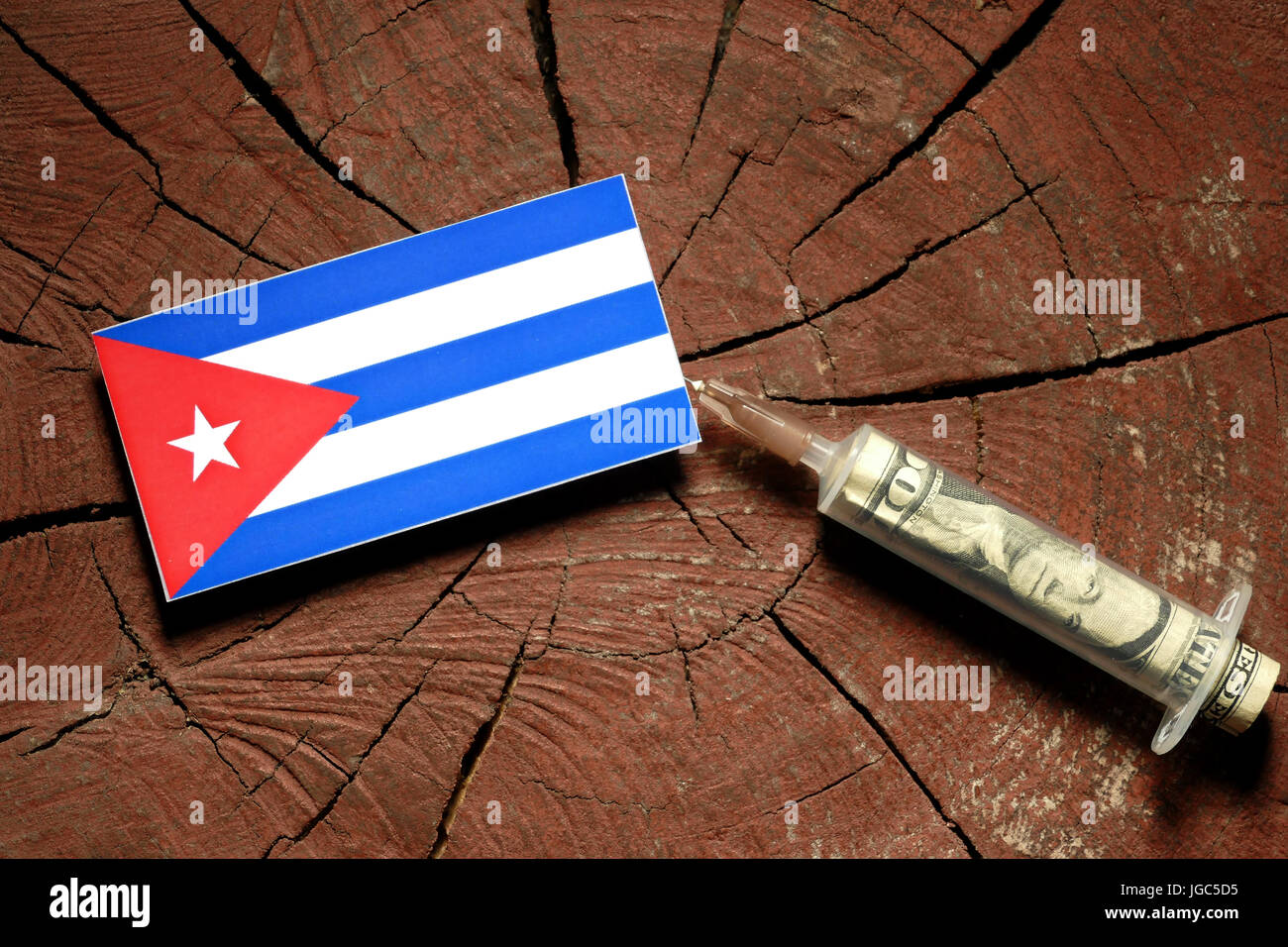 Cuban flag on a stump with syringe injecting money in flag Stock Photo ...
