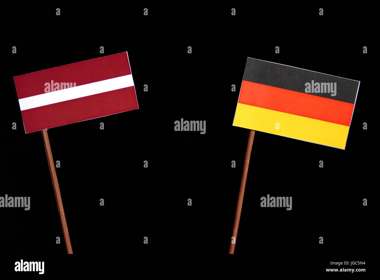 Latvia flag with German flag isolated on black background Stock Photo ...