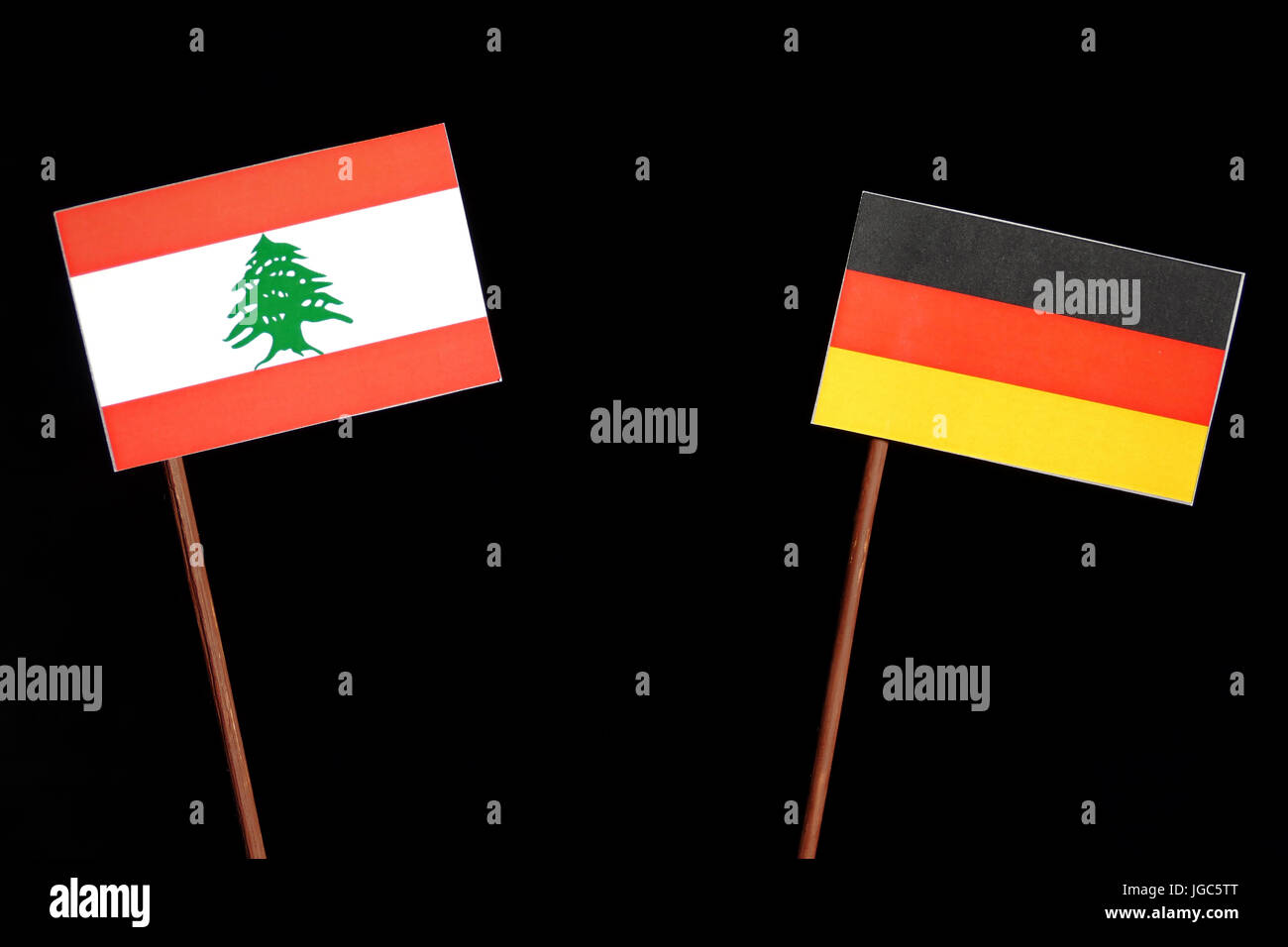 Lebanese flag with German flag isolated on black background Stock Photo ...