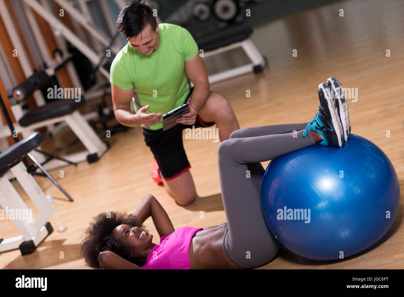 healthy young couple exercise in gym pilates workout with personal ...