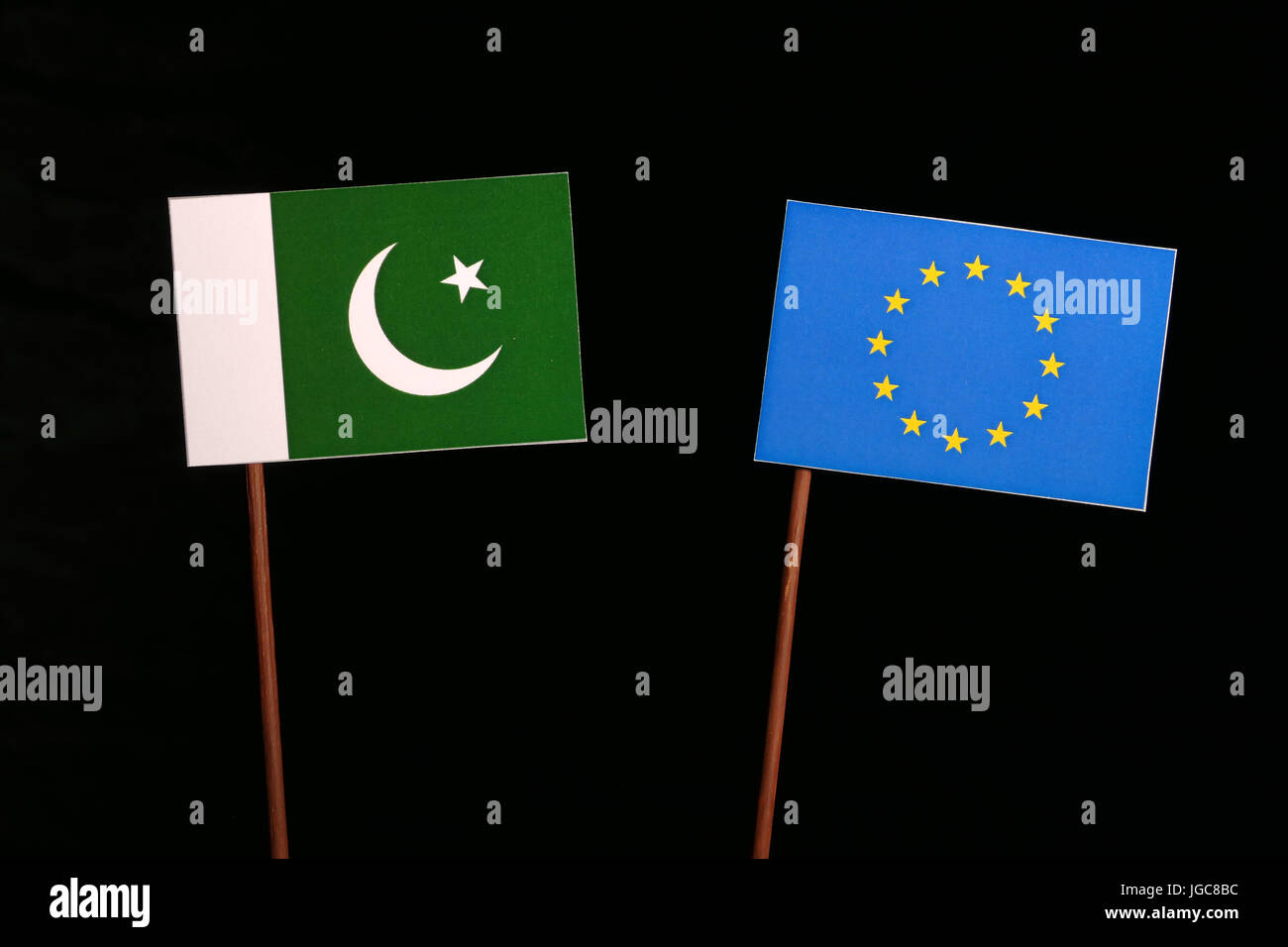 Pakistan flag with European Union (EU) flag isolated on black ...
