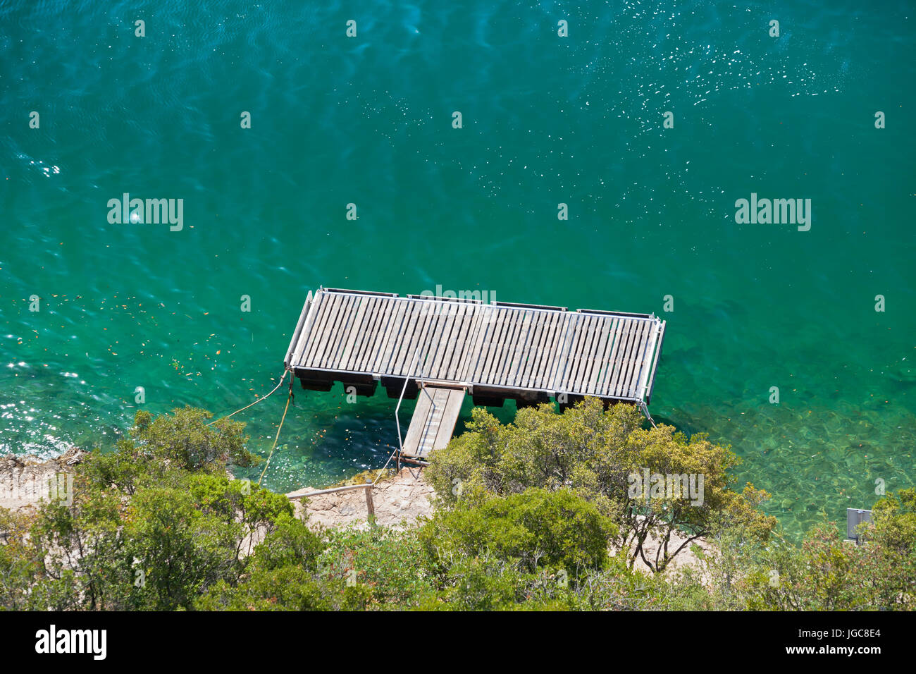 Small wooden pier on water. Top view Stock Photo - Alamy