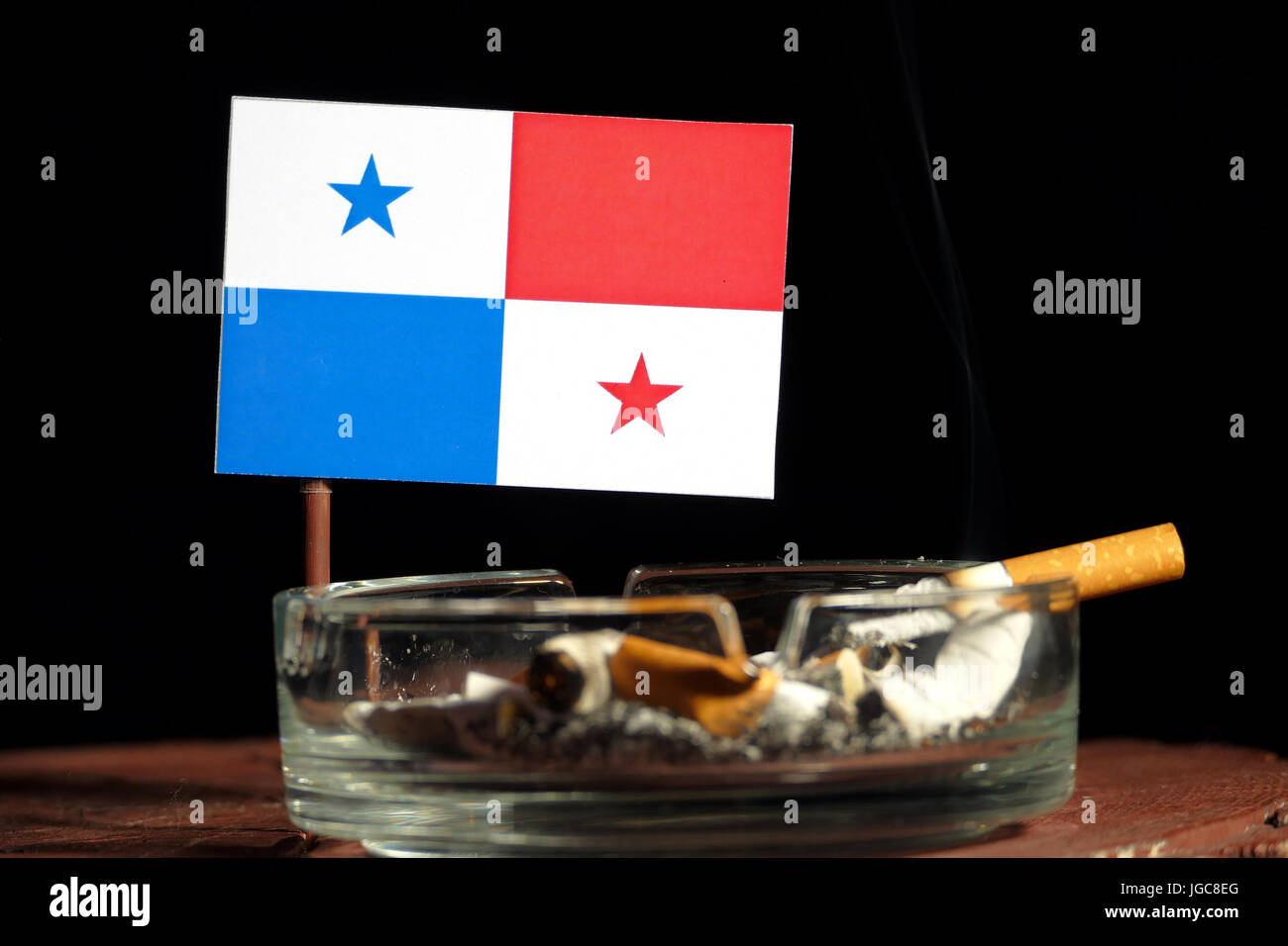 Panama flag with burning cigarette in ashtray isolated on black ...