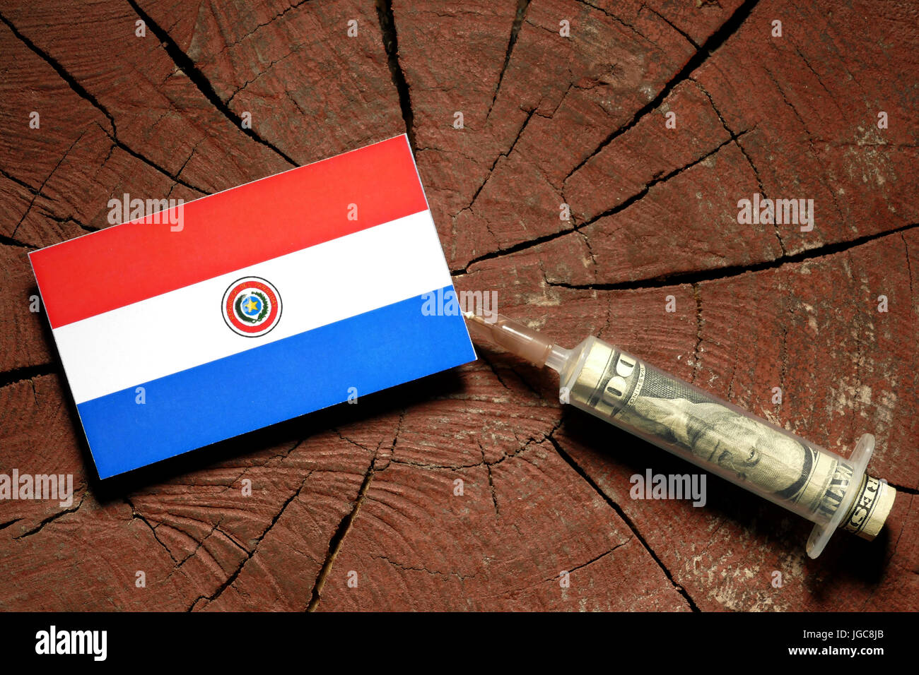 Paraguay flag on a stump with syringe injecting money in flag Stock ...