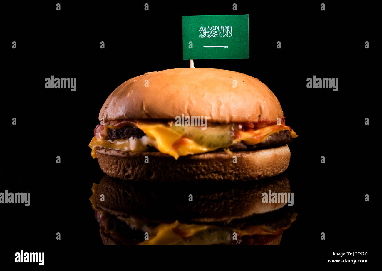 Saudi Arabian flag on top of hamburger isolated on black background ...