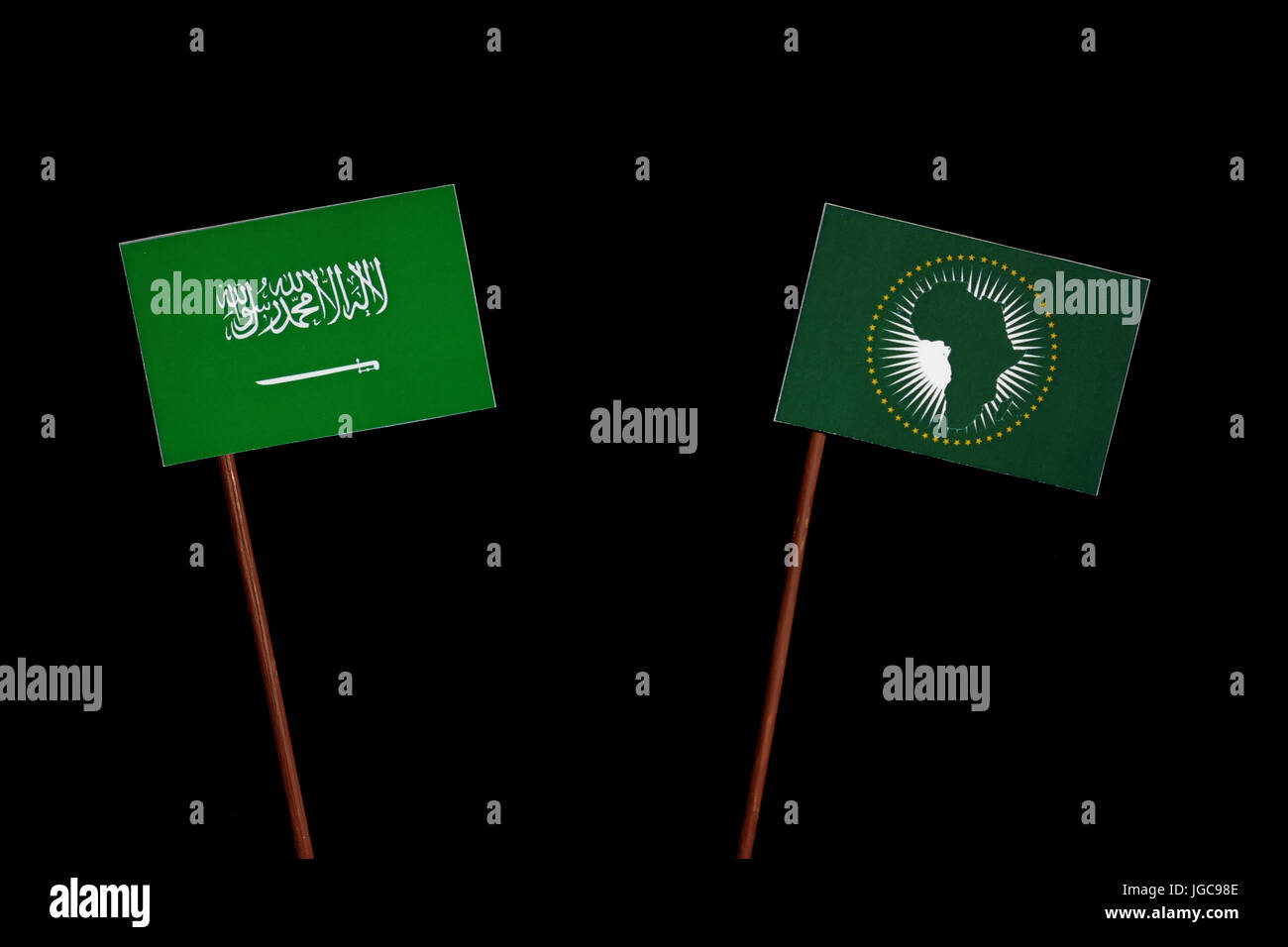 Saudi Arabian flag with African Union flag isolated on black background ...