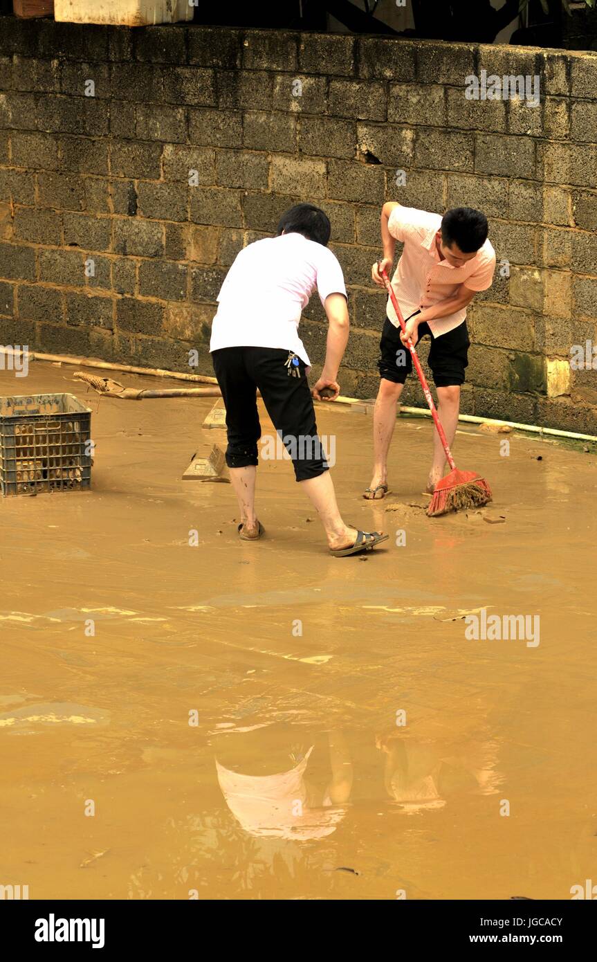 Nanning, Nanning, China. 4th July, 2017. People are busy cleaning mud ...