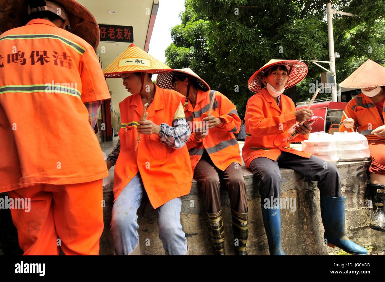 Nanning, Nanning, China. 4th July, 2017. People are busy cleaning mud ...