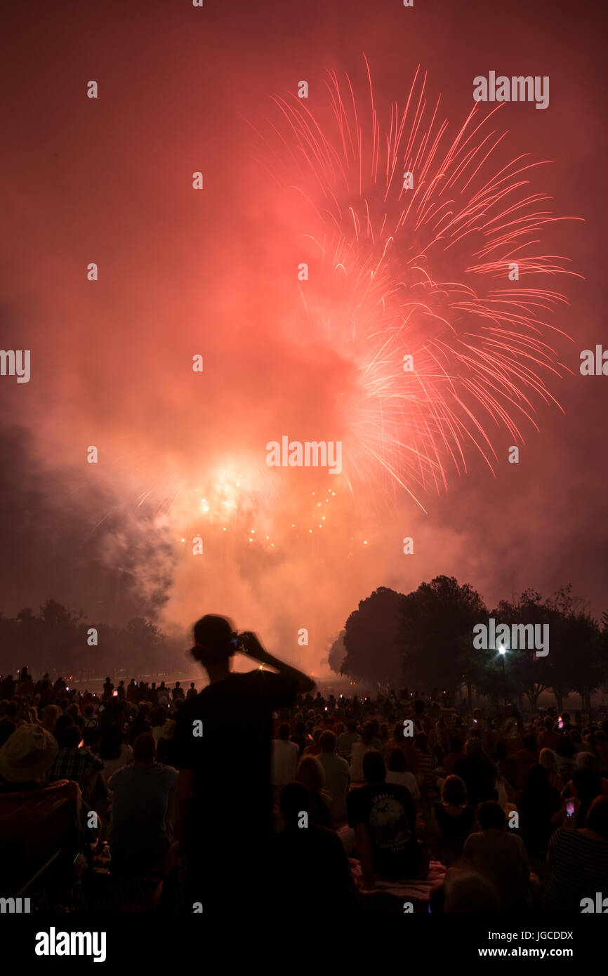 A young man photographs the Grand Finale; July 4th Fireworks Display ...