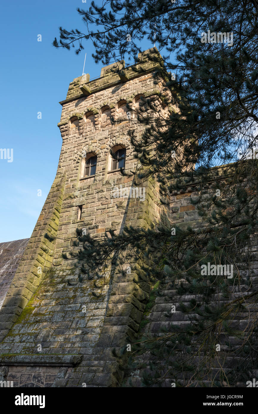 Looking up at the solid stone tower at Derwent reservoir in the Peak ...