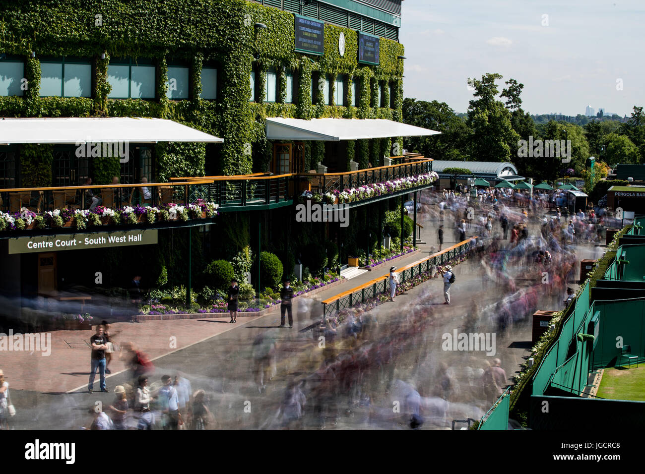 Spectators are led in on day three of the Wimbledon Championships at ...