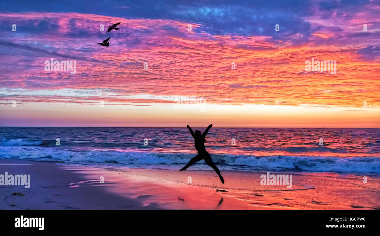 Silhouette of a woman Jumping on the beach at sunset, Australia Stock ...