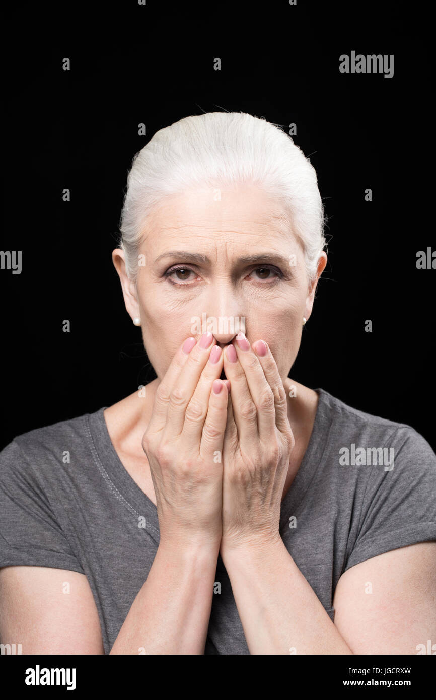 portrait of scared grey hair woman isolated on black Stock Photo - Alamy