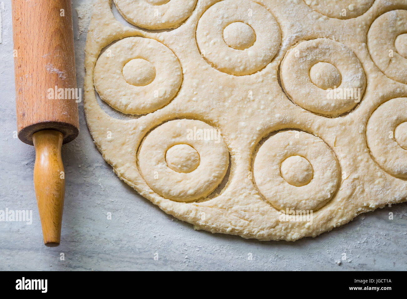 Cutting from fresh dough homemade and sweet donuts Stock Photo - Alamy