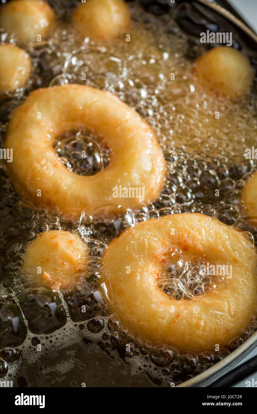 Frying tasty and homemade donuts on fresh oil Stock Photo - Alamy