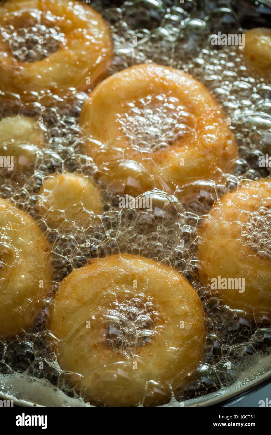 Frying homemade and sweet donuts on hot oil Stock Photo - Alamy