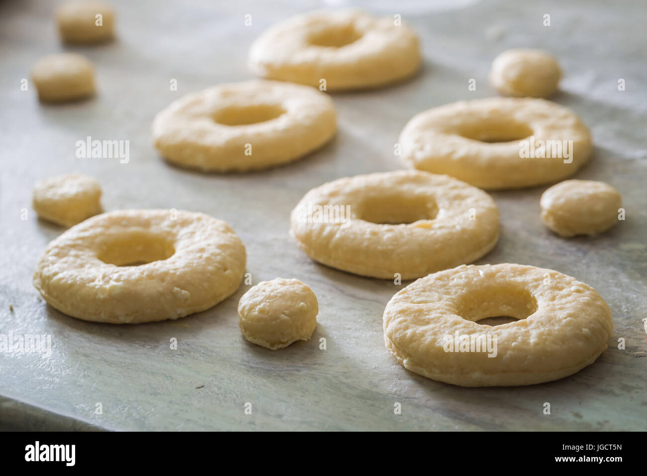 Cutting from fresh dough traditionally and delicious donuts Stock Photo ...
