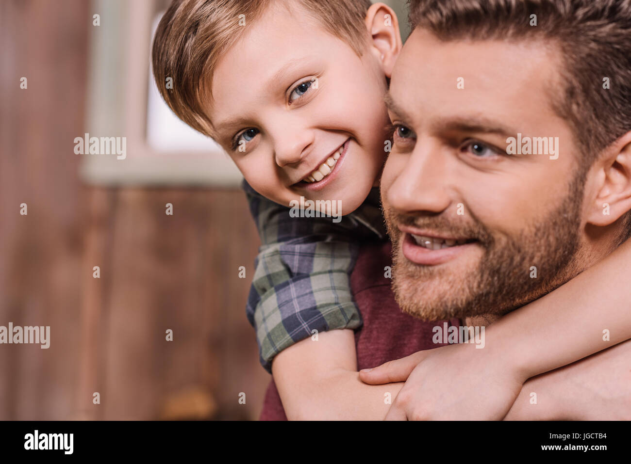 young father with little son sitting on porch at backyard, dad and son ...