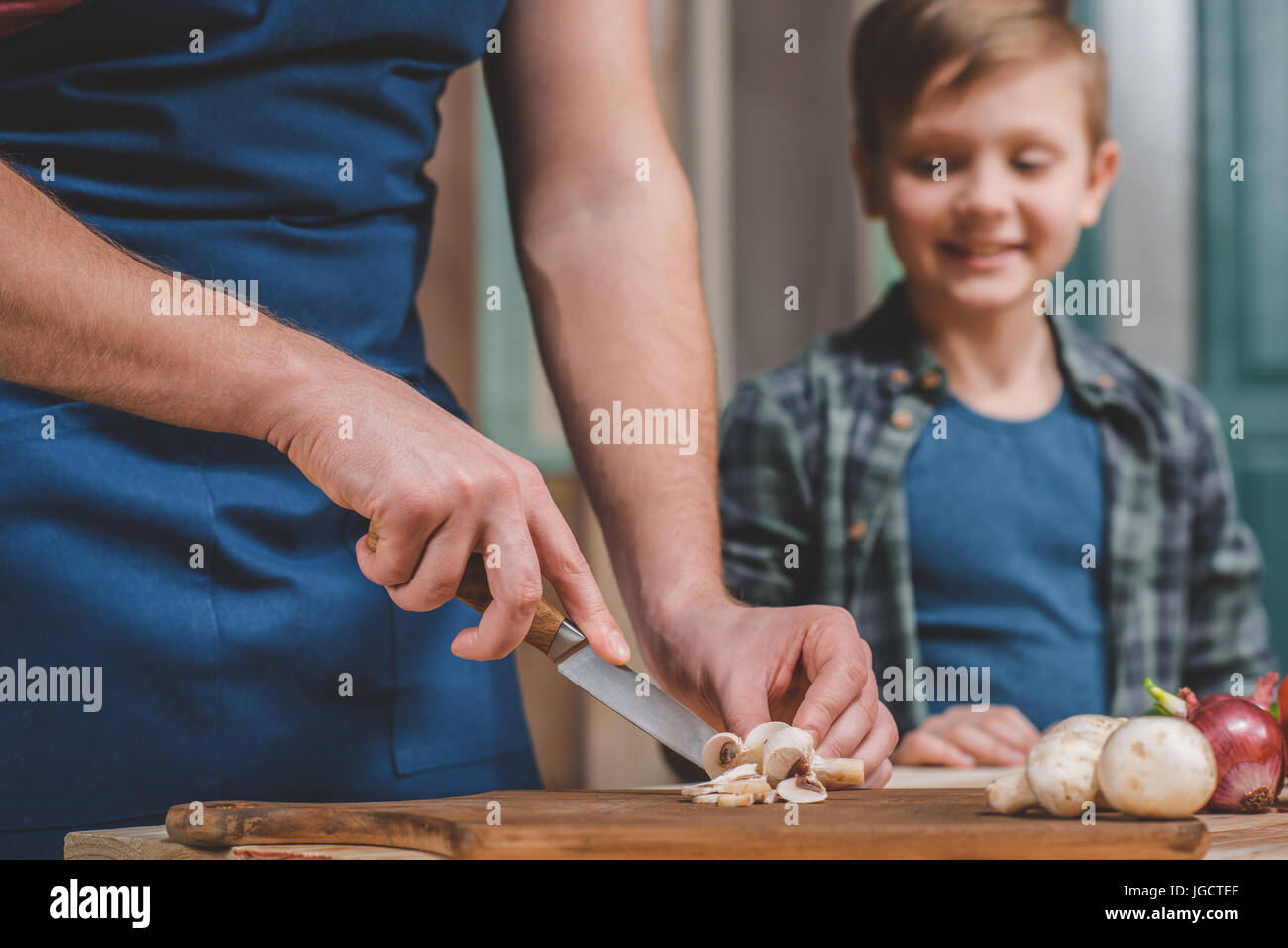 father with little son preparing food on table at backyard, dad and son ...