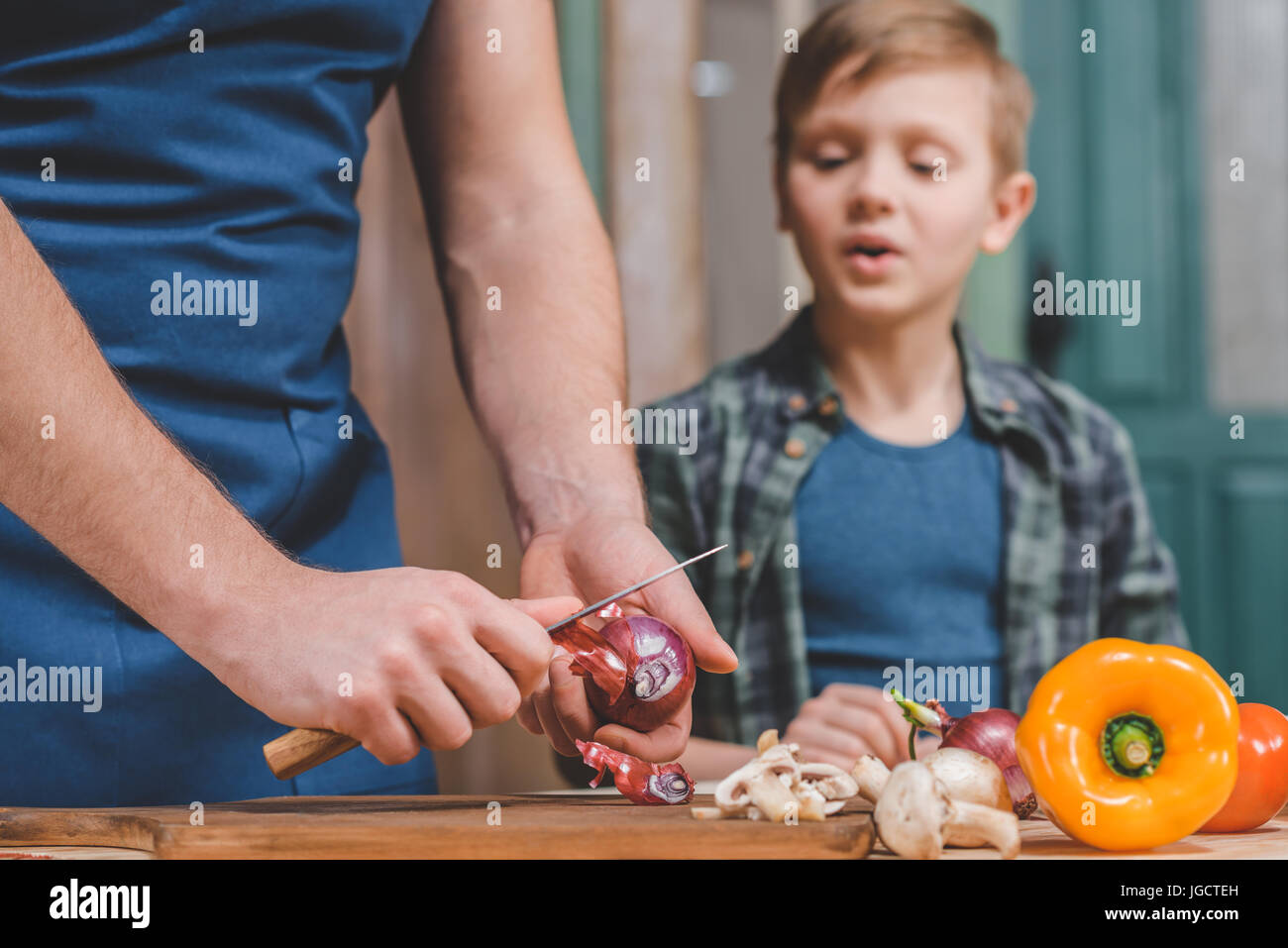father with little son preparing food on table at backyard, dad and son ...