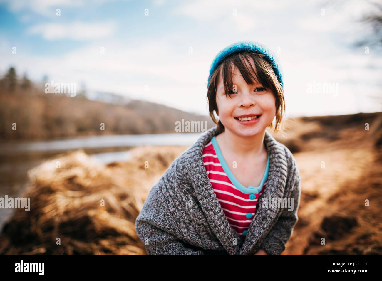 Portrait of a smiling girl by a river Stock Photo - Alamy