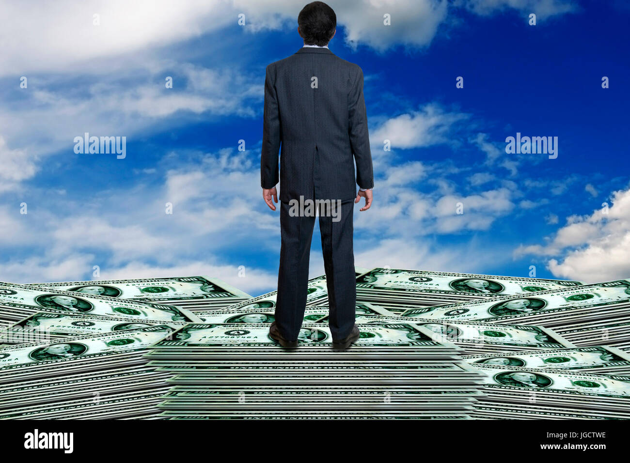 businessman standing on stacks of dollars Stock Photo - Alamy