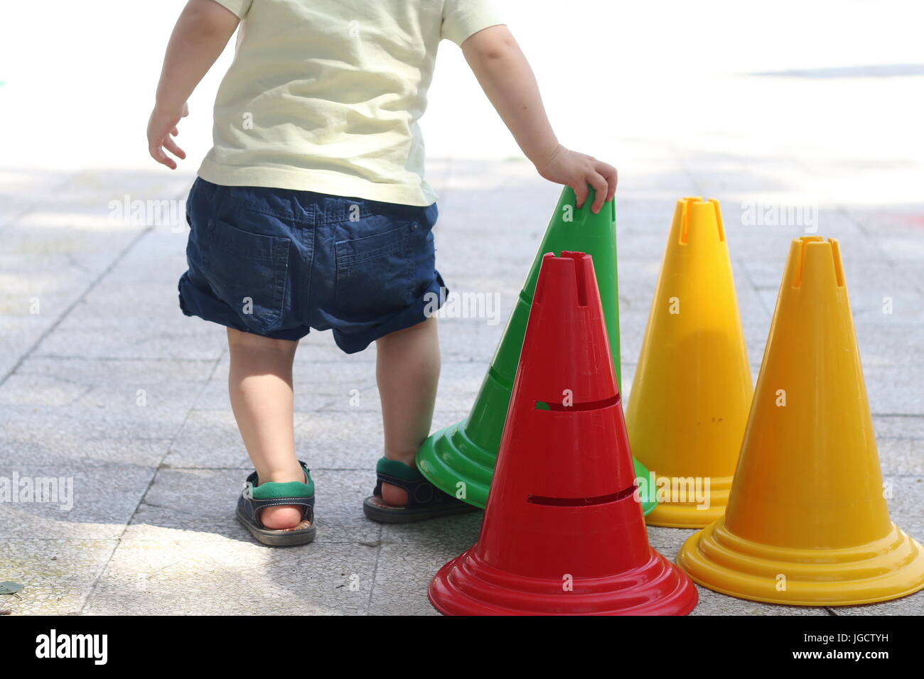 Boy playing with a cone Stock Photo - Alamy