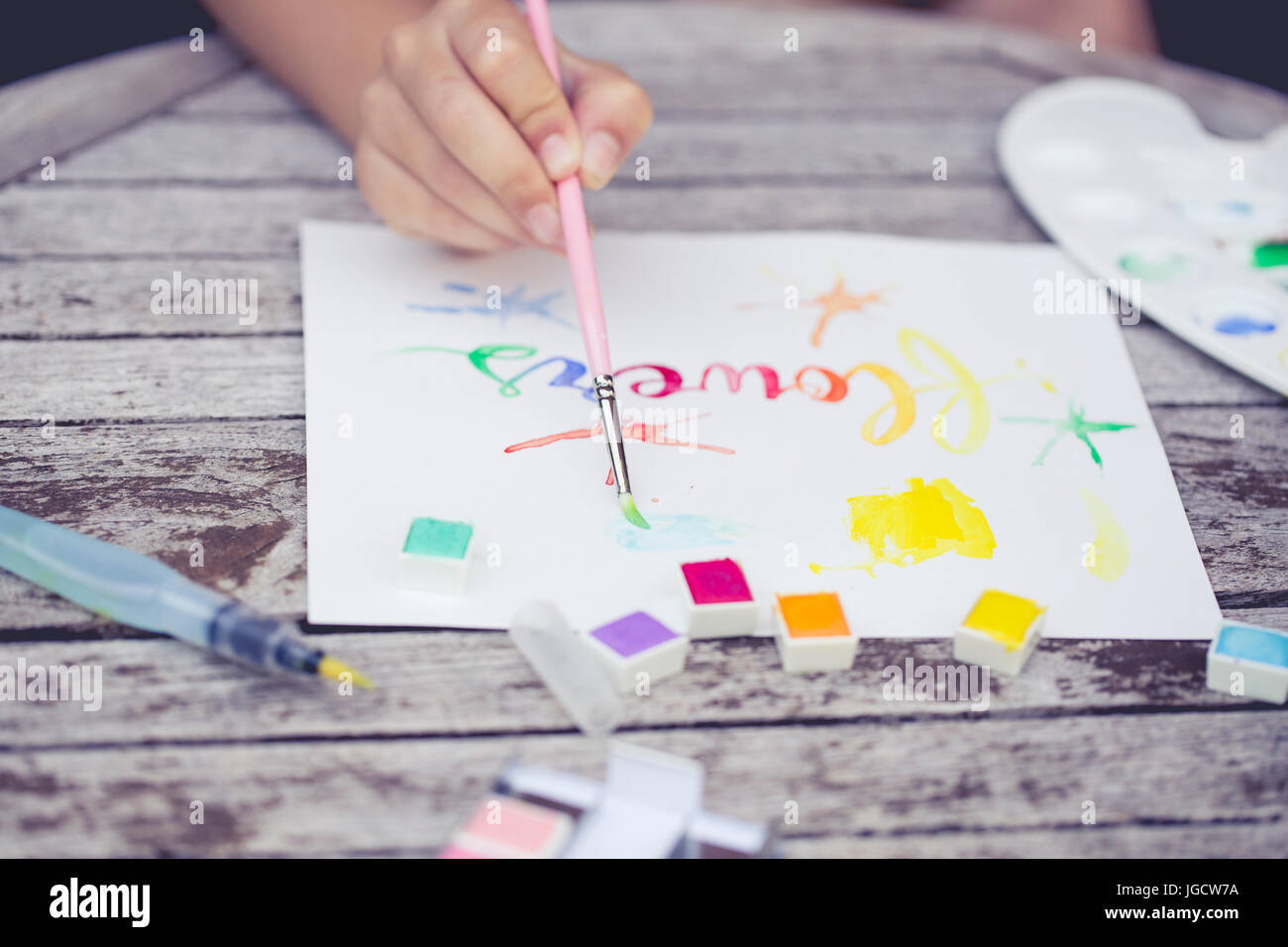 Boy painting with watercolour paints Stock Photo - Alamy