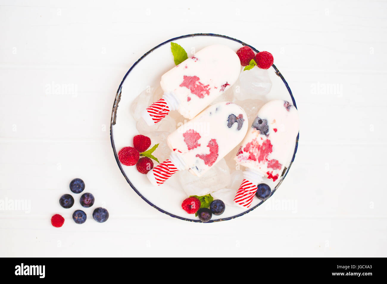 Three milk ice creams, with blueberries and raspberries Stock Photo - Alamy