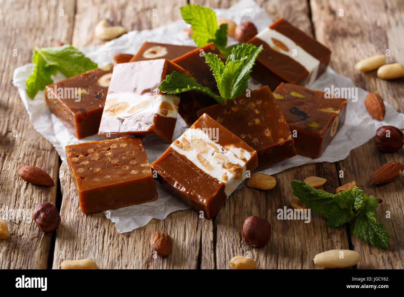 Square sweets toffee with nuts decorated with mint closeup on a table ...