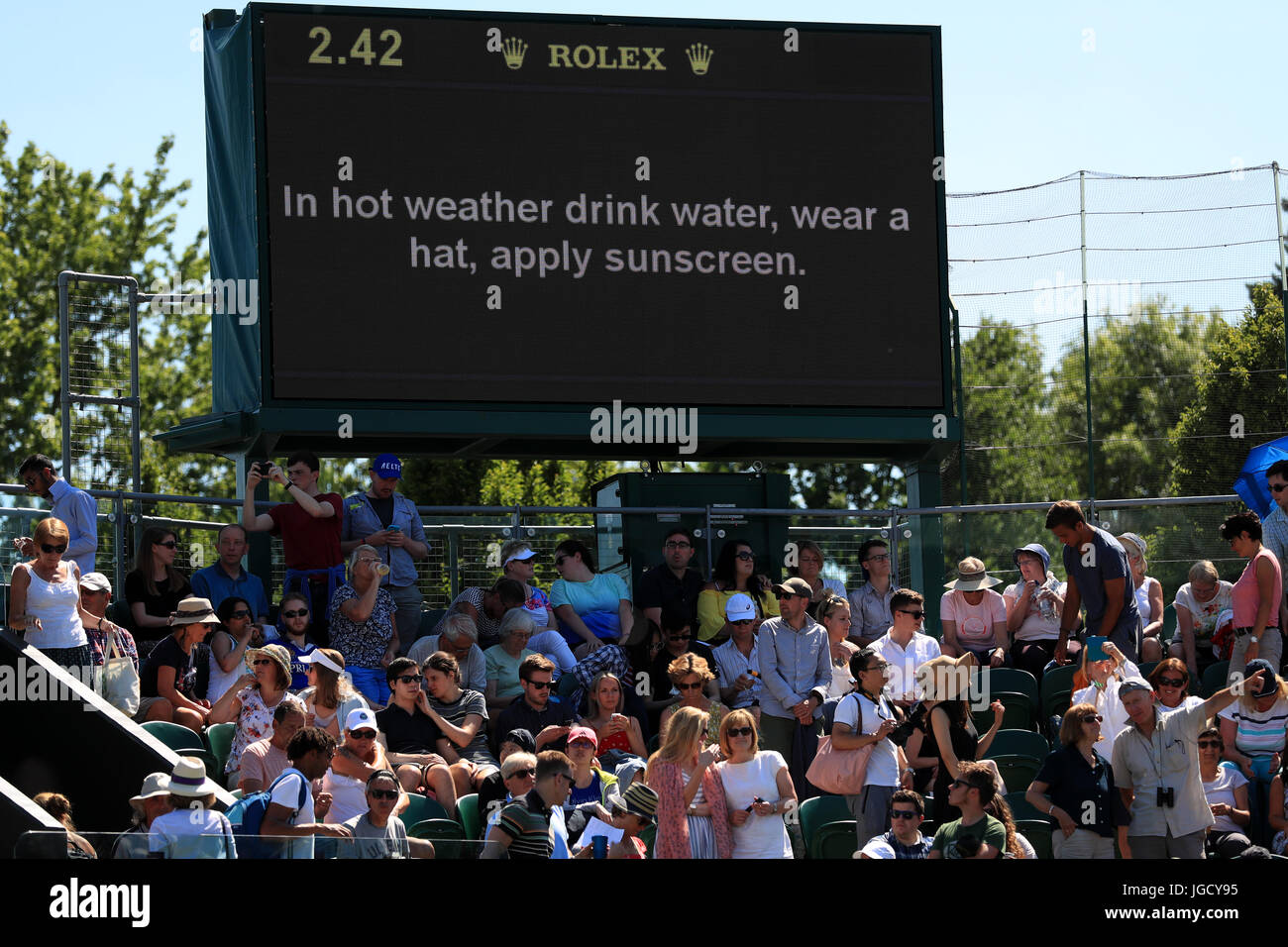 A hot weather warning is displayed on a big screen warning spectators ...