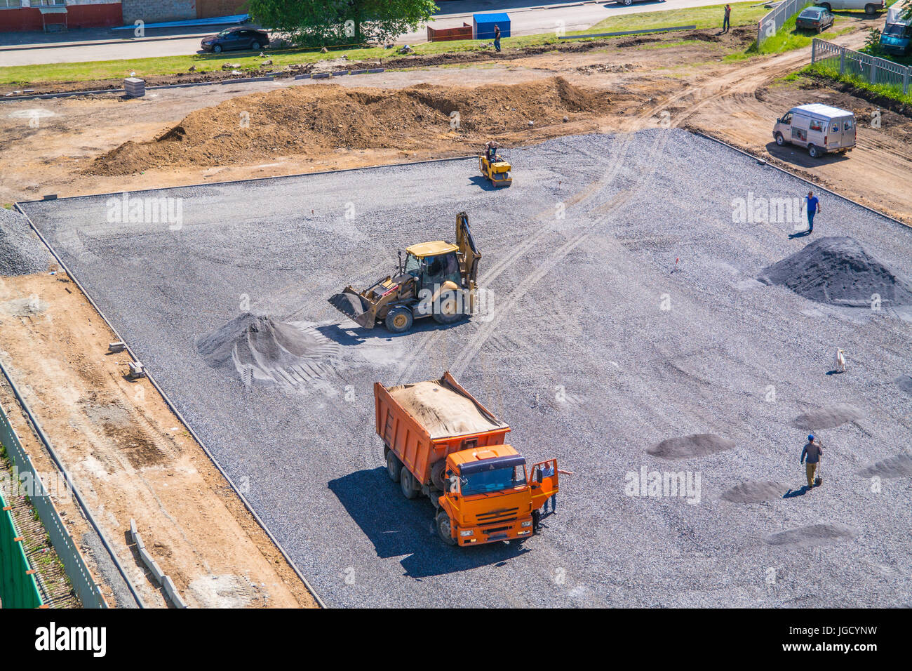 The construction of the school stadium. Excavator, dumper, roller Stock ...