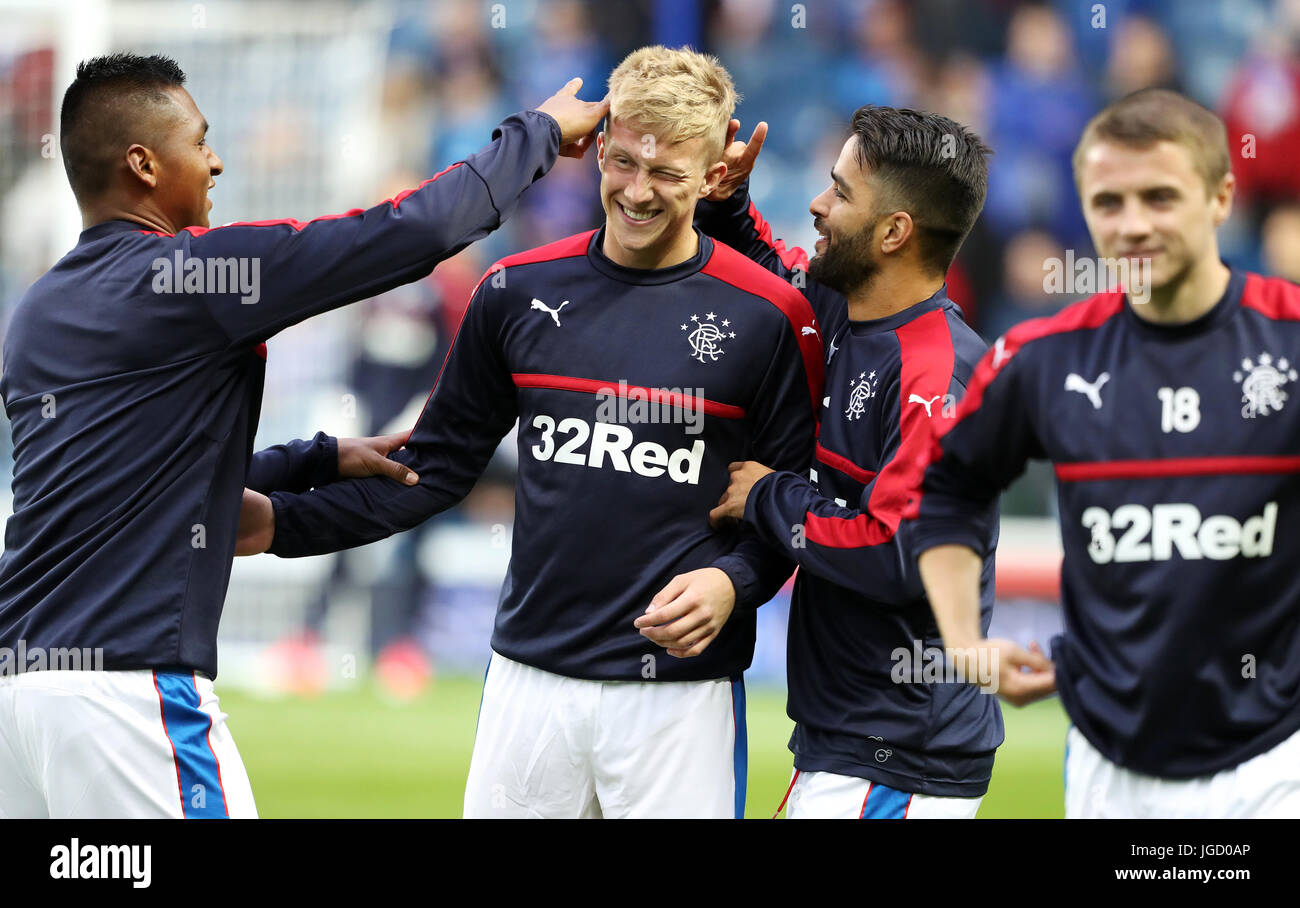 Rangers' Ross McCrorie (centre) has his ears flicked by team-mates ...