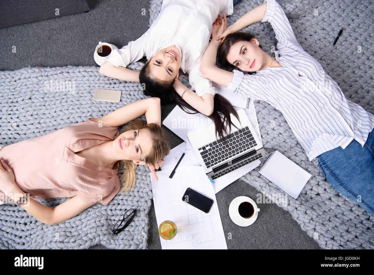 top view of businesswomen lying on floor while having break Stock Photo ...