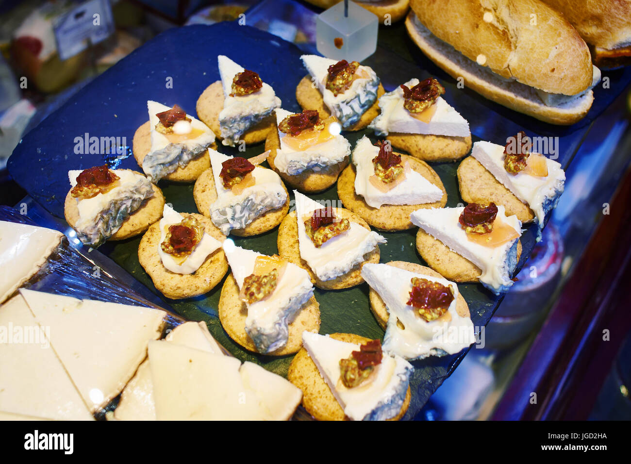 Sandwiches with brie cheese and vegetable garnish on store shelves ...